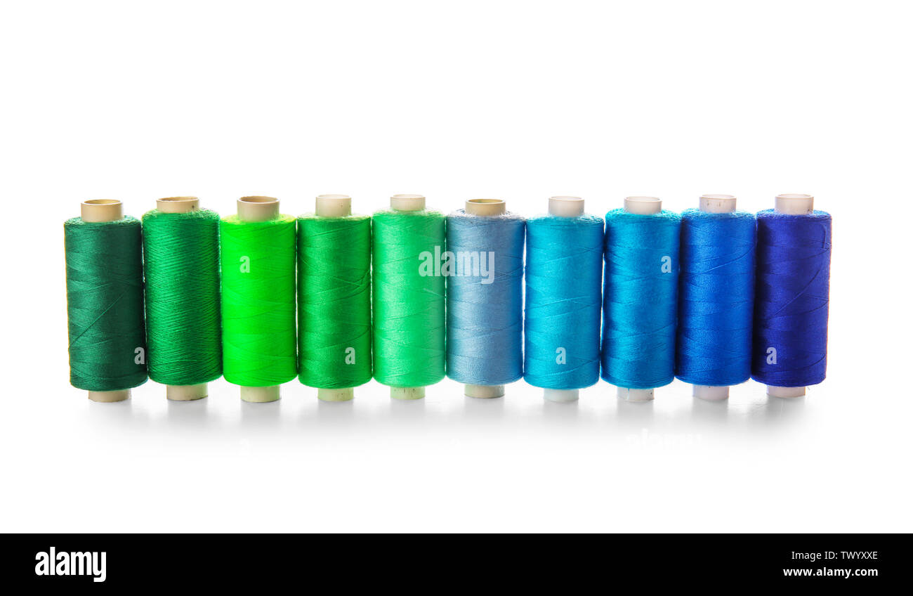 Colorful sewing threads on white background Stock Photo - Alamy