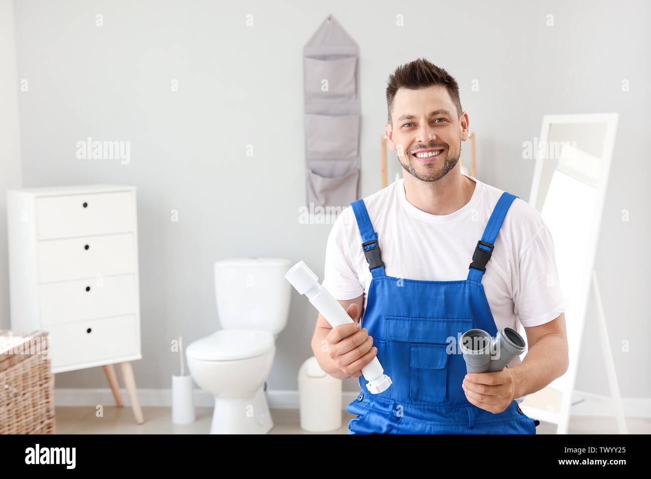 Portrait of handsome plumber in restroom Stock Photo - Alamy