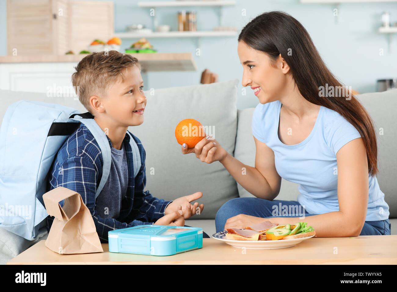 Mother boy packing backpack hi-res stock photography and images - Alamy