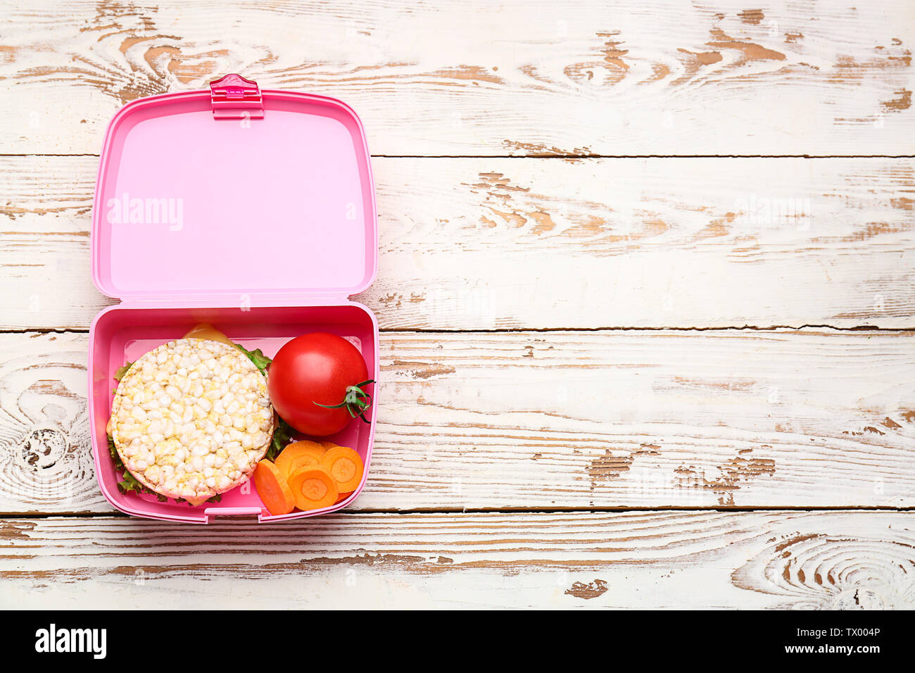 Lunch box with tasty food on wooden background Stock Photo - Alamy