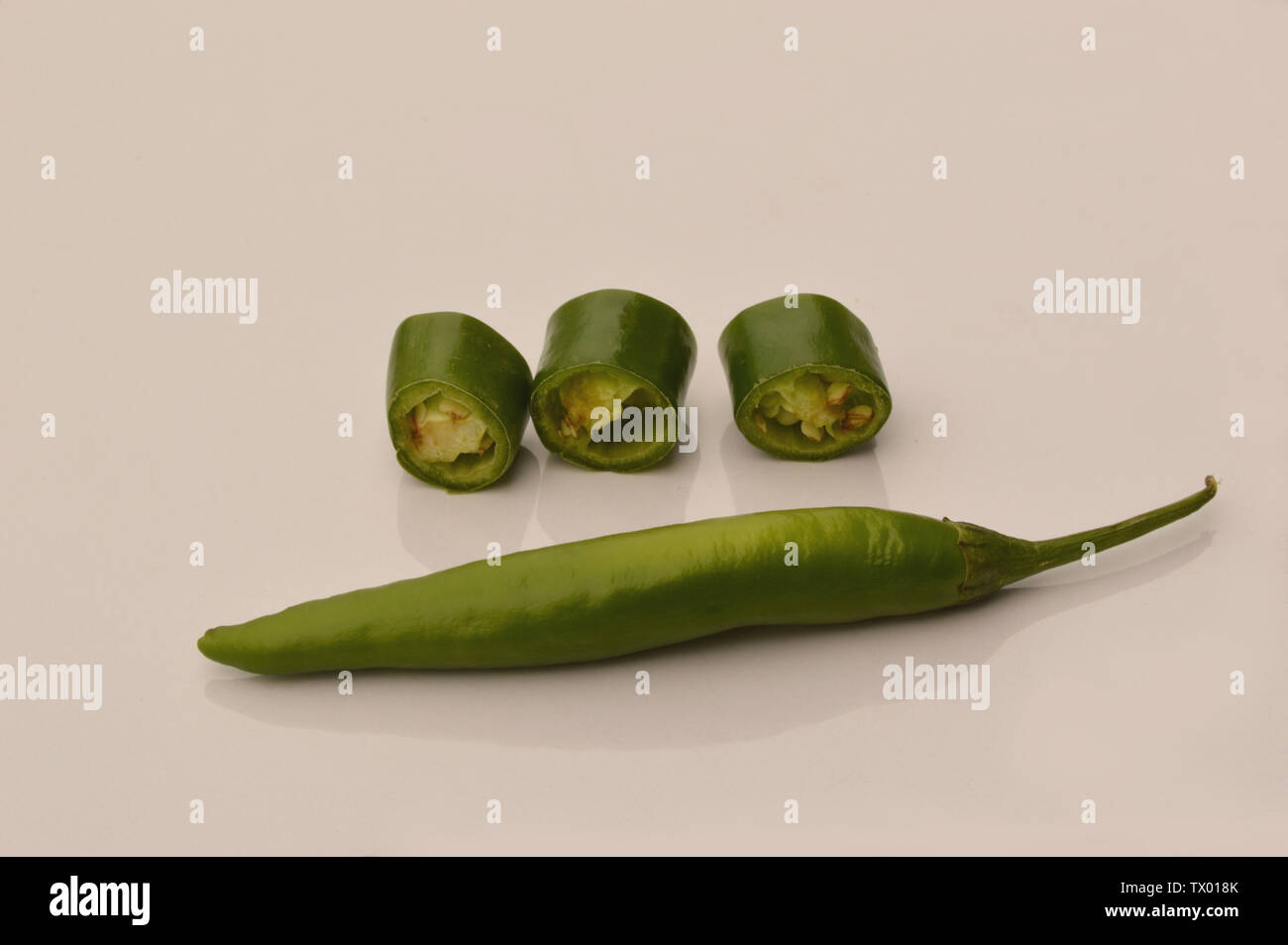 Fresh green spicy chili, whole and sliced fresh chili from a home ...