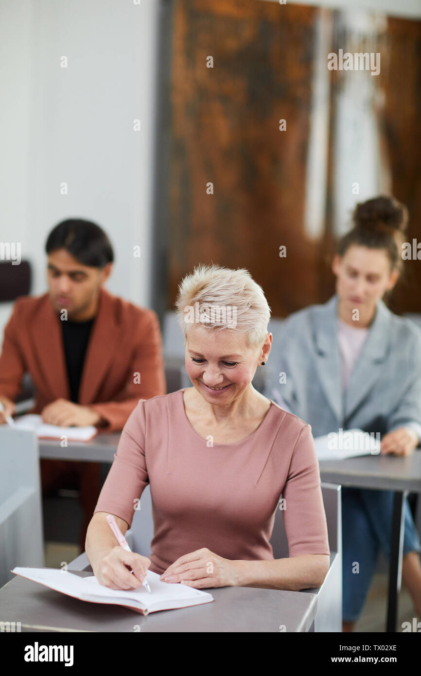 Woman taking notes in class hi-res stock photography and images - Alamy