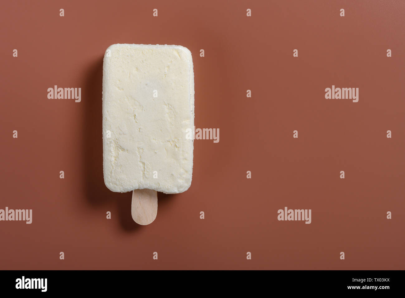top view fresh milkshake flavor popsicle on a brown background with ...