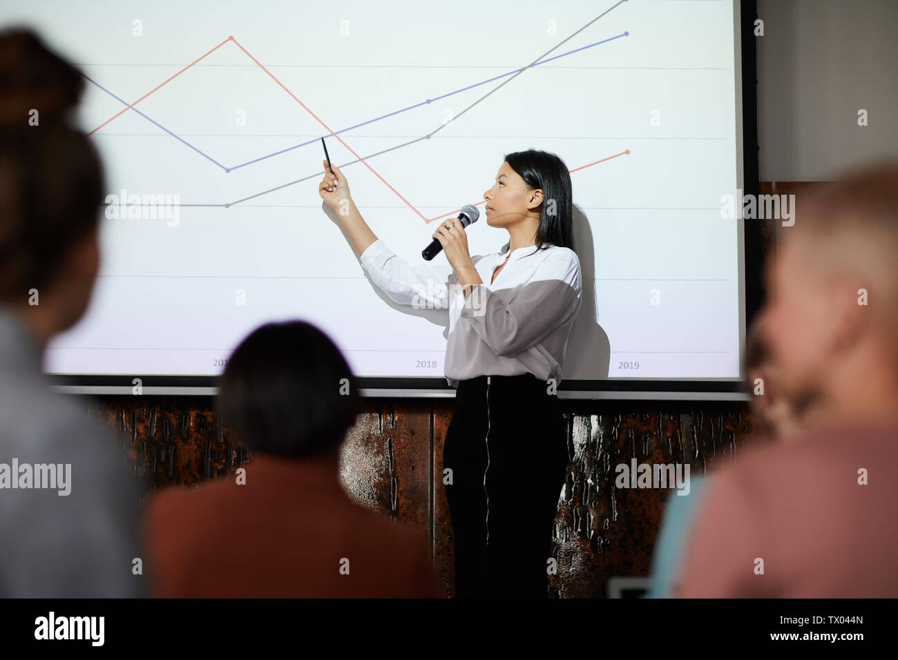 Side view portrait of contemporary businesswoman giving presentation ...