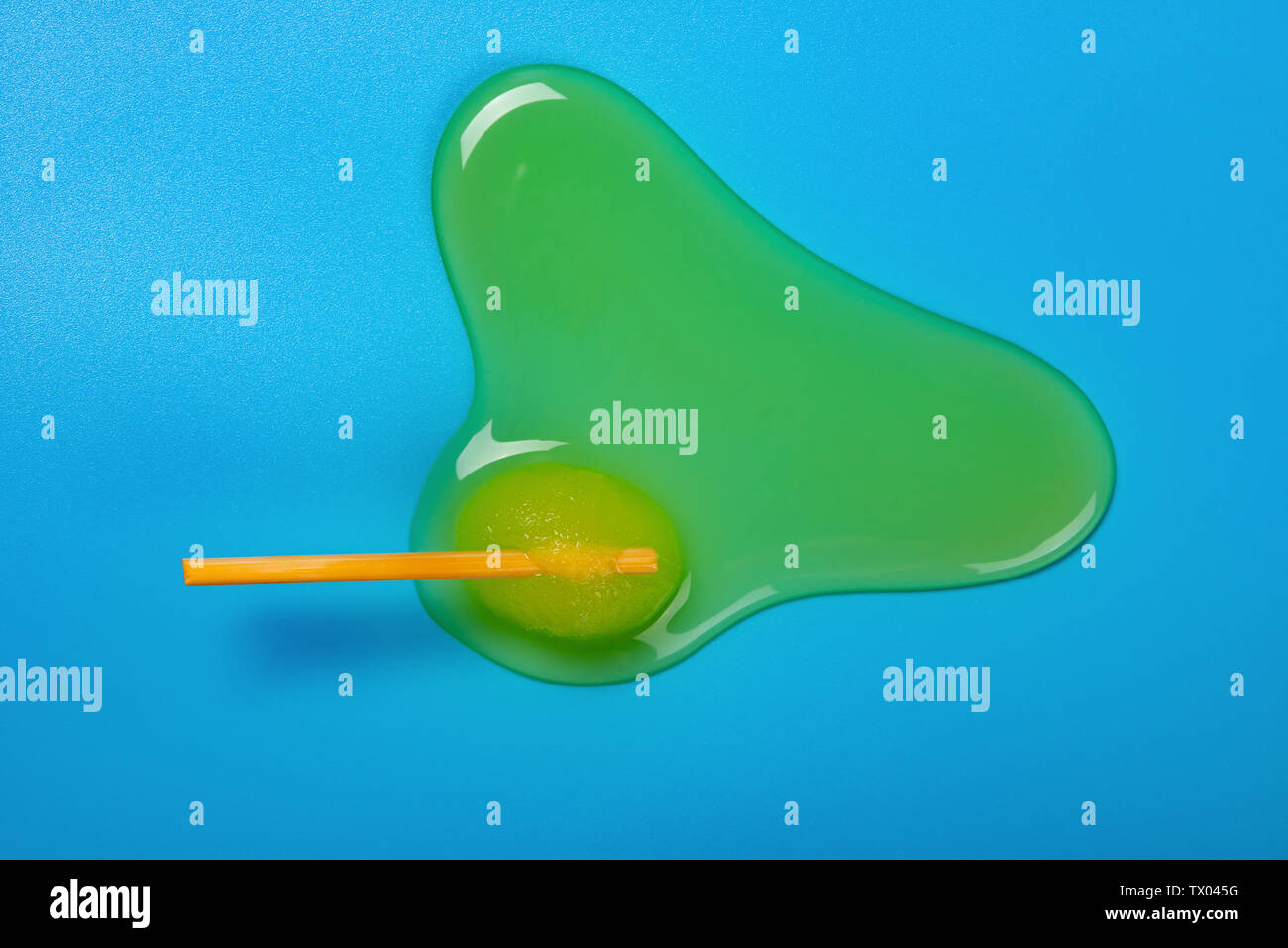 top view green color mini size popsicle melt on a blue background Stock ...