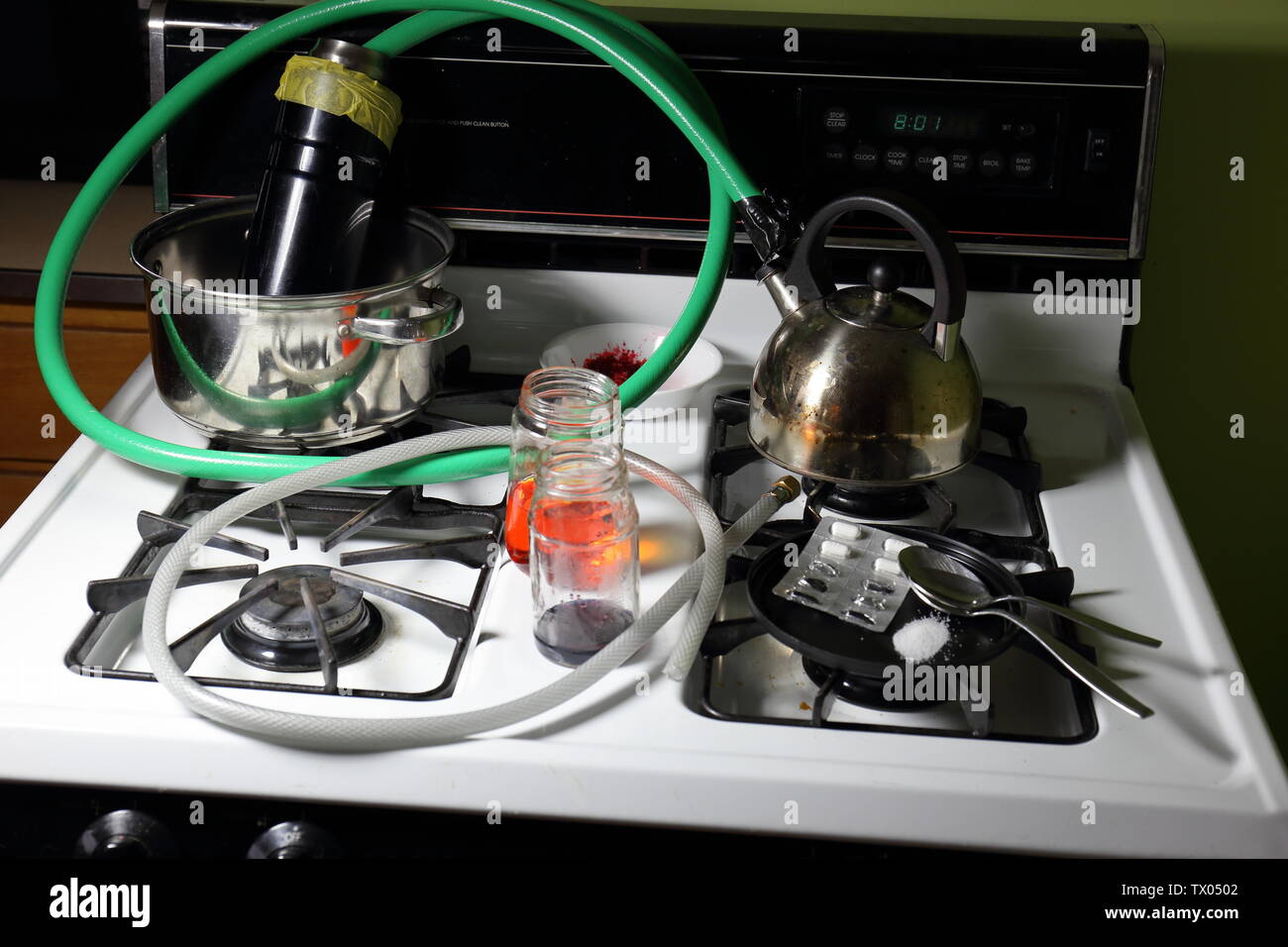 Crudely constructed meth lab on a stove top consisting of crushed nasal ...