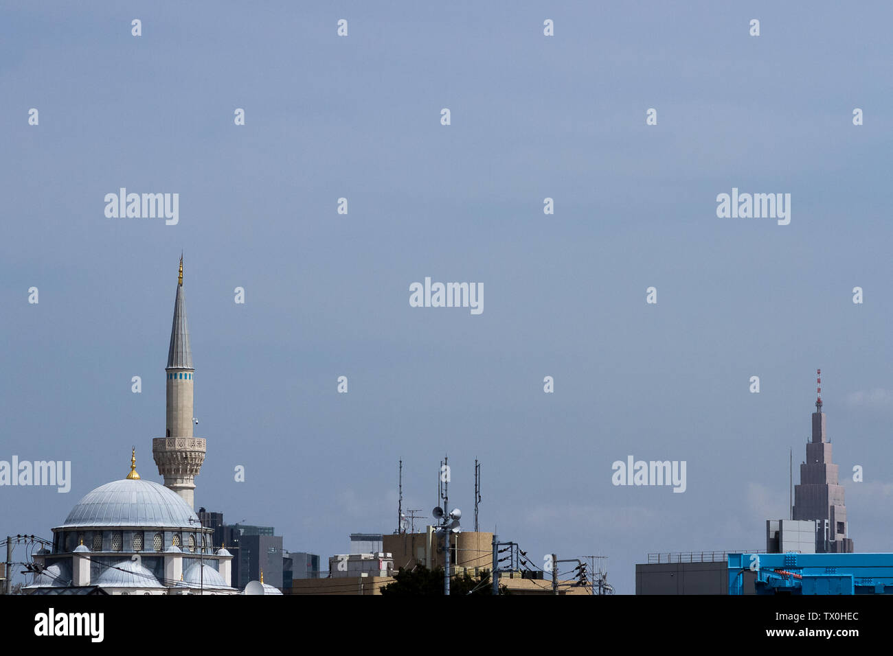 The dome and minaret of the Tokyo Camii Mosque (left) with the Docomo ...