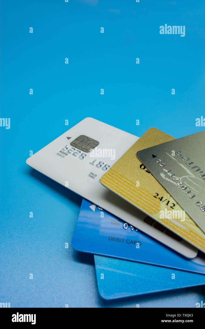 Bank cards stacked together in a blue background Stock Photo - Alamy