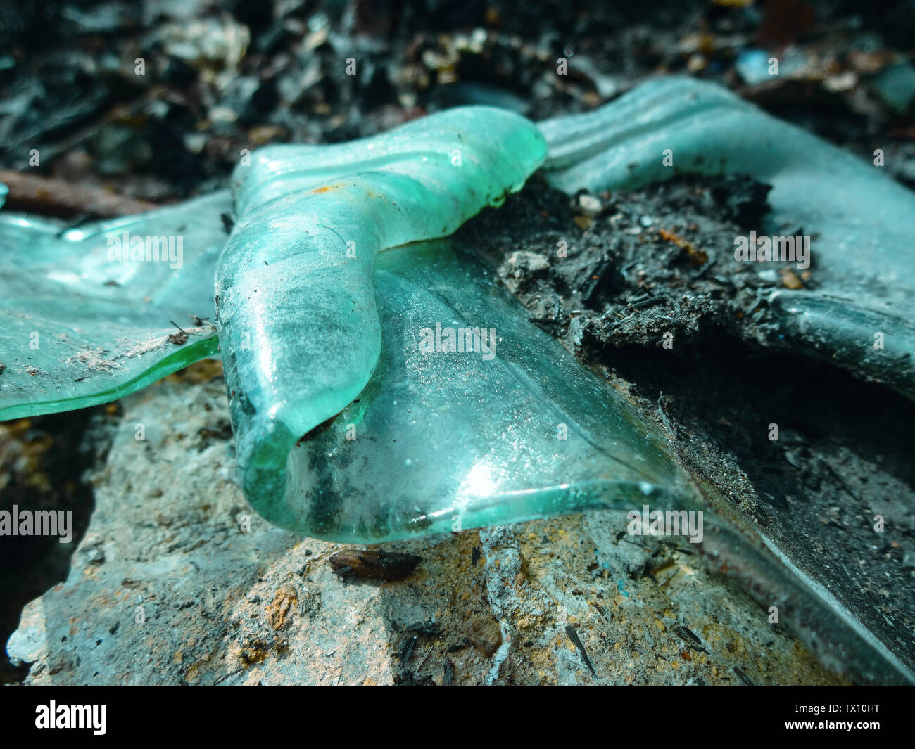 Burned, melted glass cans Stock Photo - Alamy