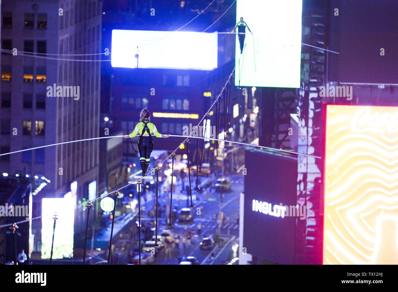 Nik and Lijana Wallenda walk a high wire across Times Square, New York ...