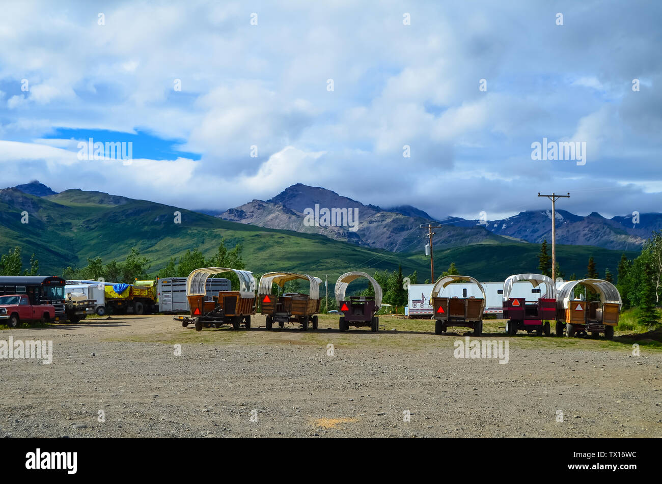 Wells Fargo horse wagons with mountains in the background and cloudy ...