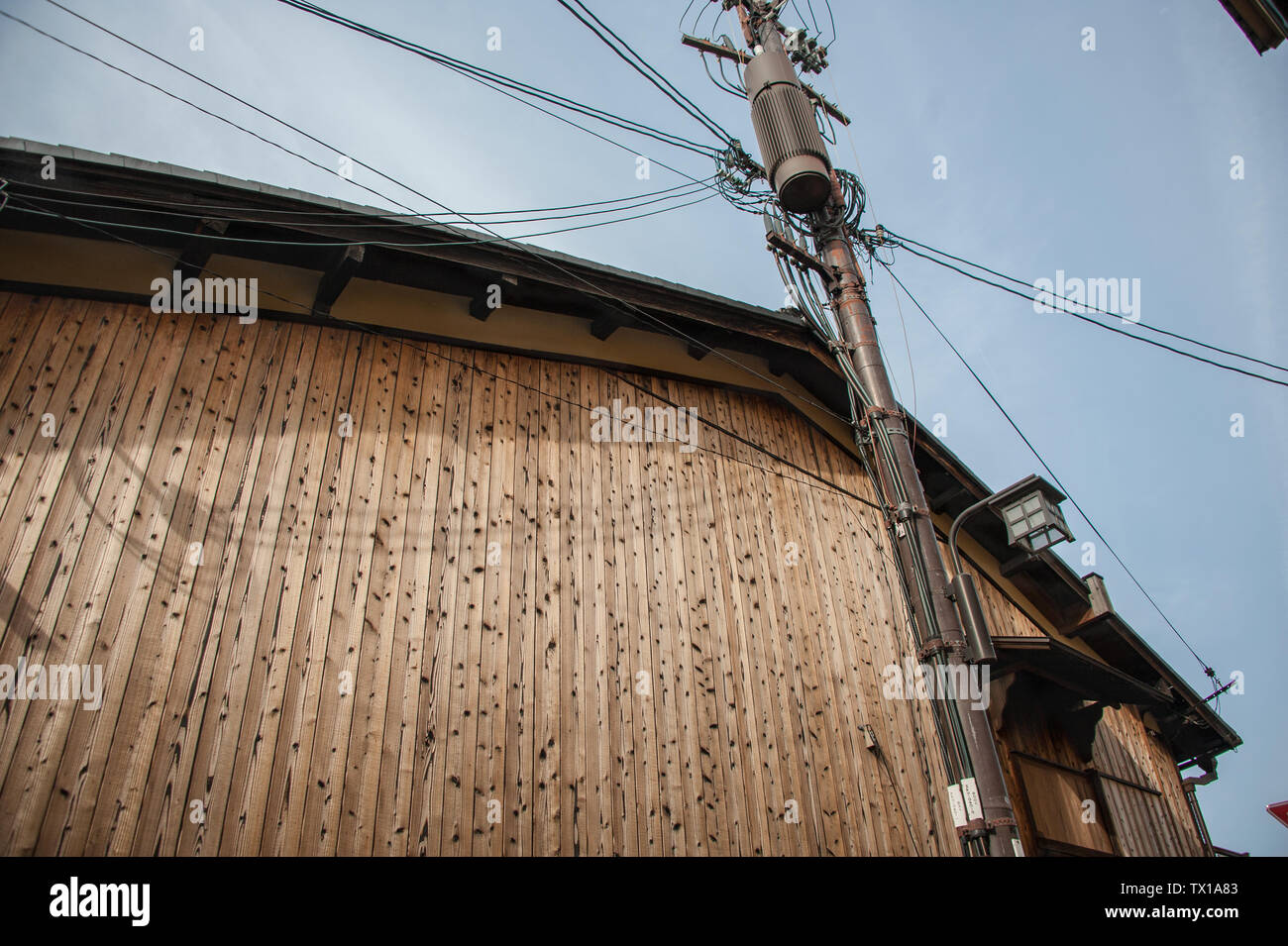 Overhead power lines and old wooden building in the Gion District of ...
