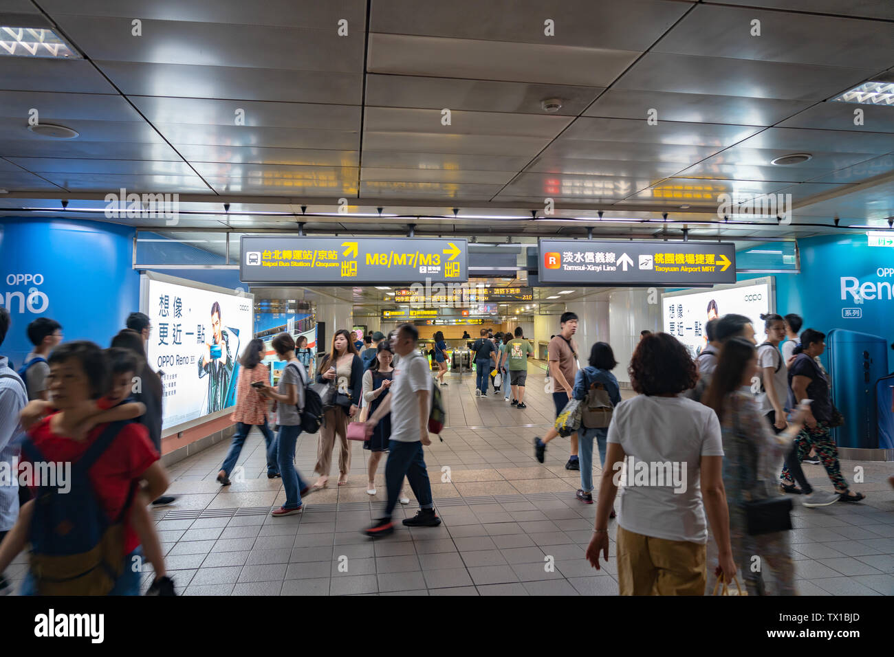 Taipei metro station hall and platform. Subway passengers walk through ...