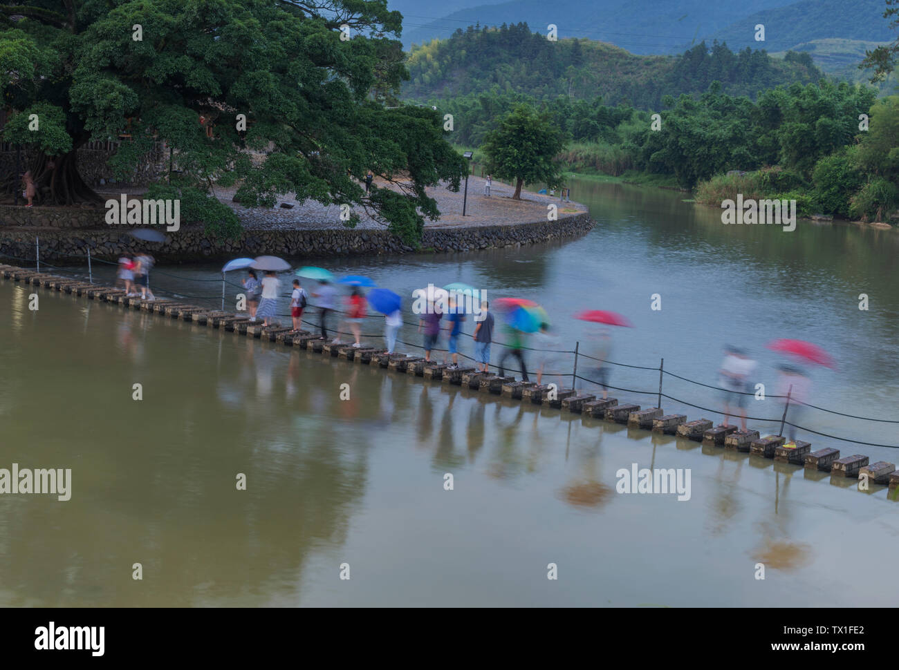 Cross the river in the rain Stock Photo - Alamy