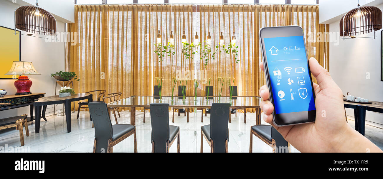 smart phone with smart home with modern dining room Stock Photo - Alamy