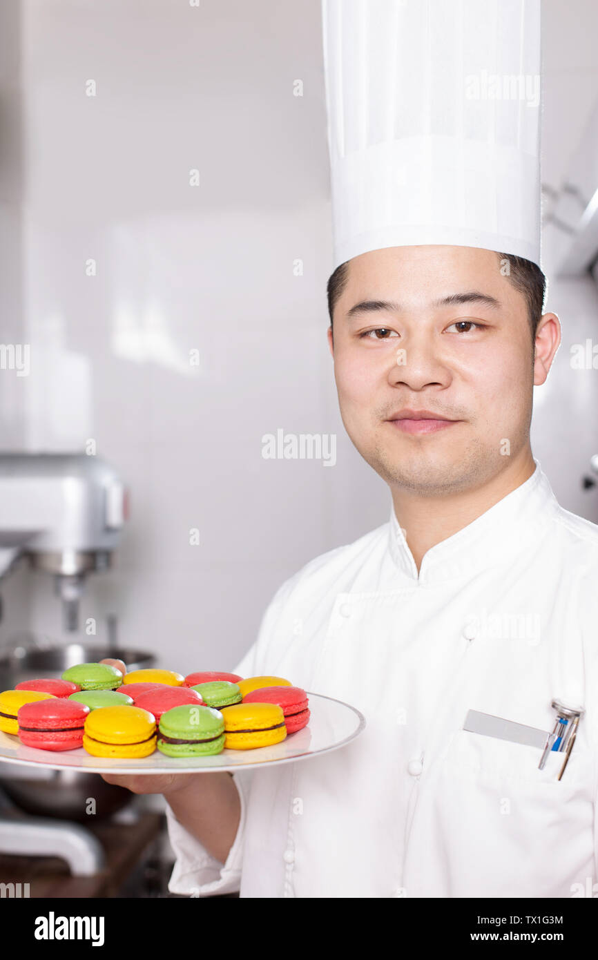 young chinese man chelf making food in modern kitchen Stock Photo - Alamy
