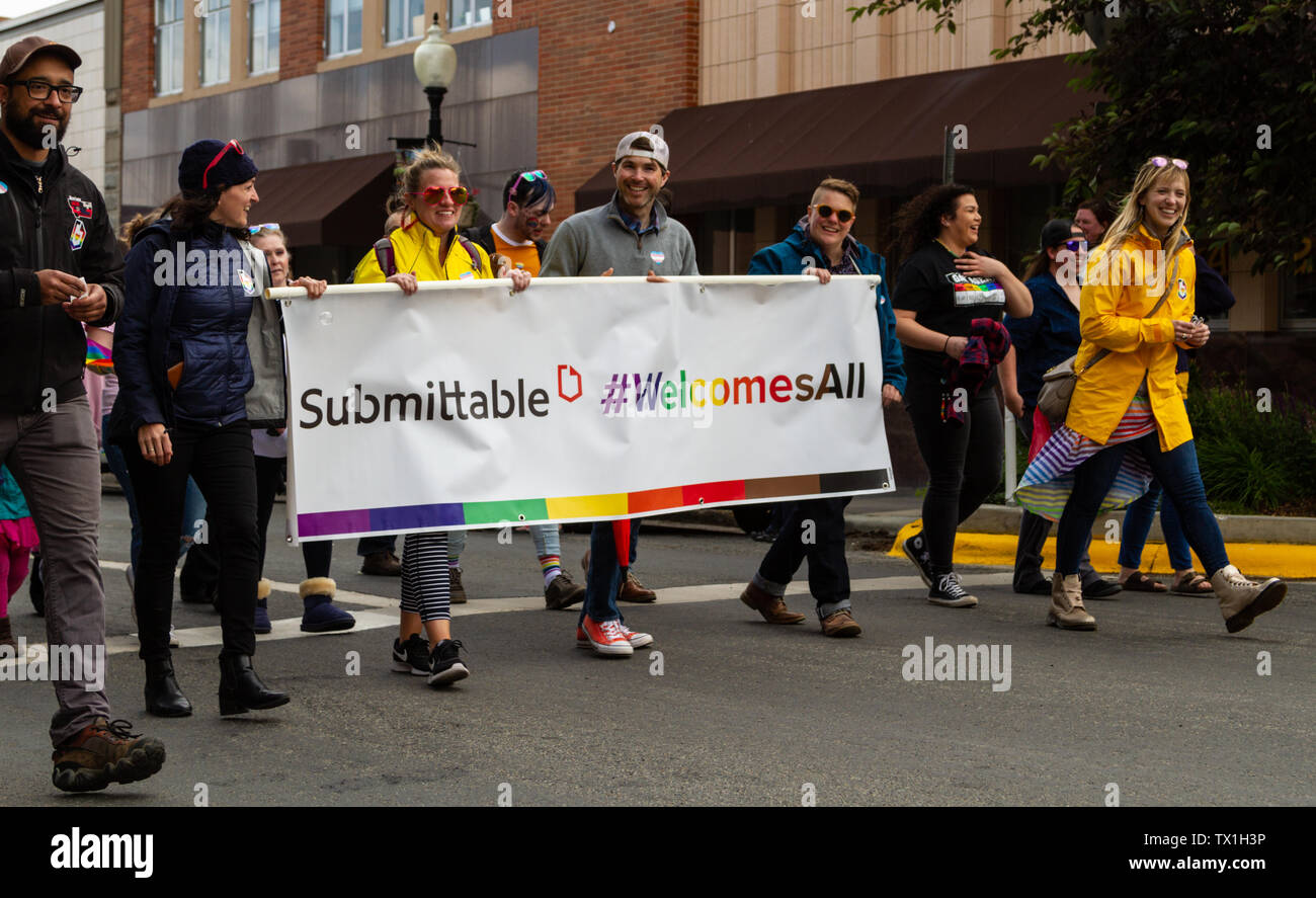 Submittable #WelcomesAll sign being marched in the 2019 Big Sky Pride ...