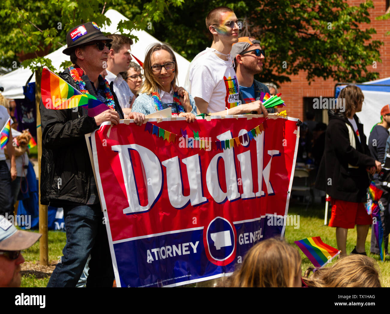 A group of supporters hold a campaign sign for Democrat Kimberly Dudik ...