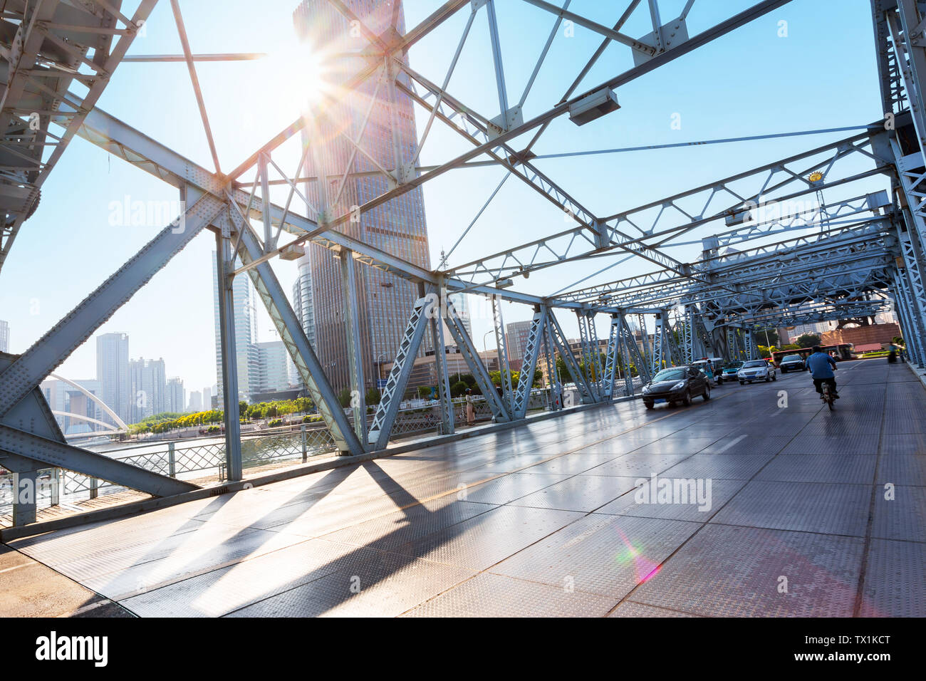 Traffic on steel bridge interior and skyline at sunset Stock Photo - Alamy