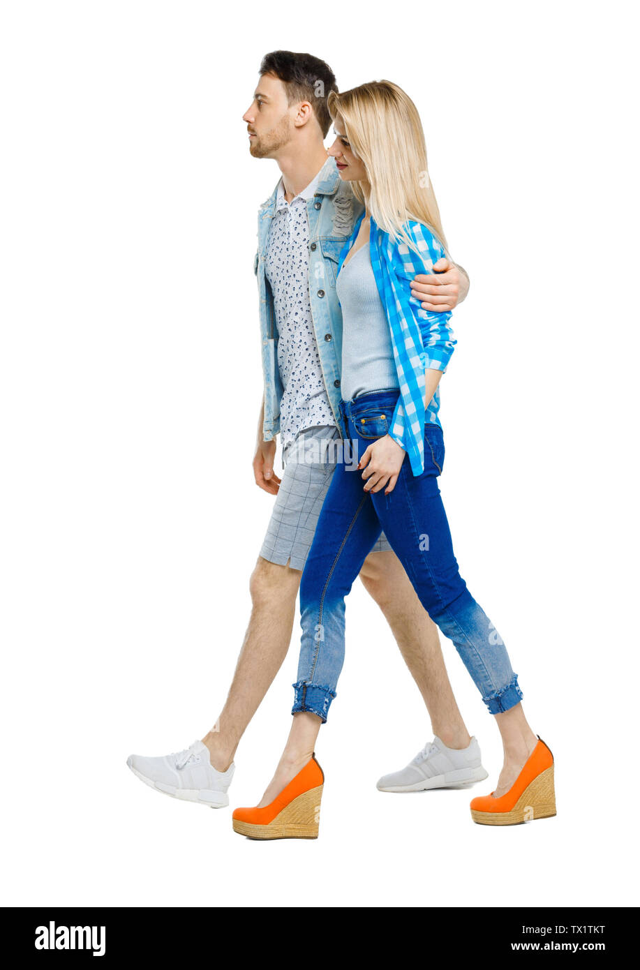 Side view of going couple. walking friendly girl and guy holding hands ...