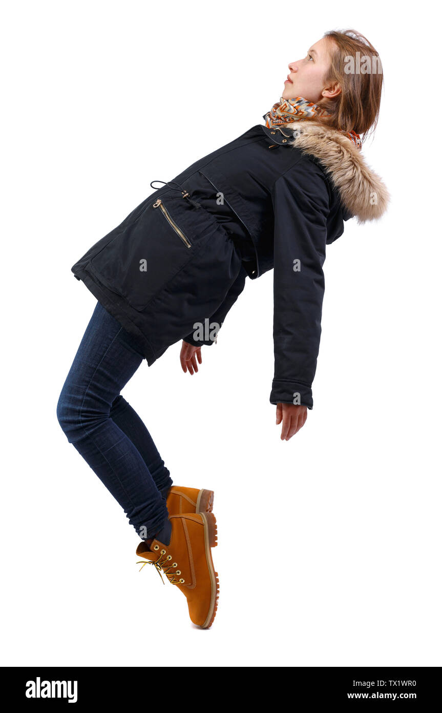 Side view of a woman in winter jacked dancing ballet. The girl is ...