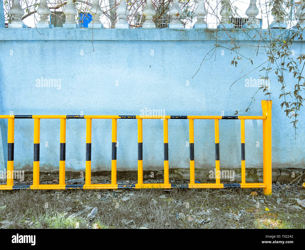 Metal fence against the wall Stock Photo - Alamy