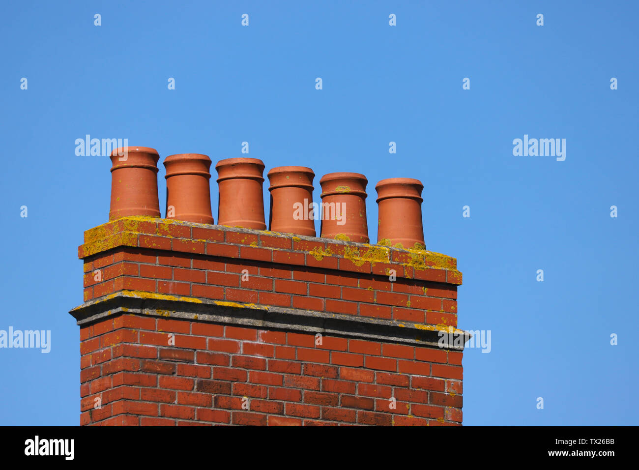 Victorian red terracotta clay chimney pots mounted on top of a red clay ...