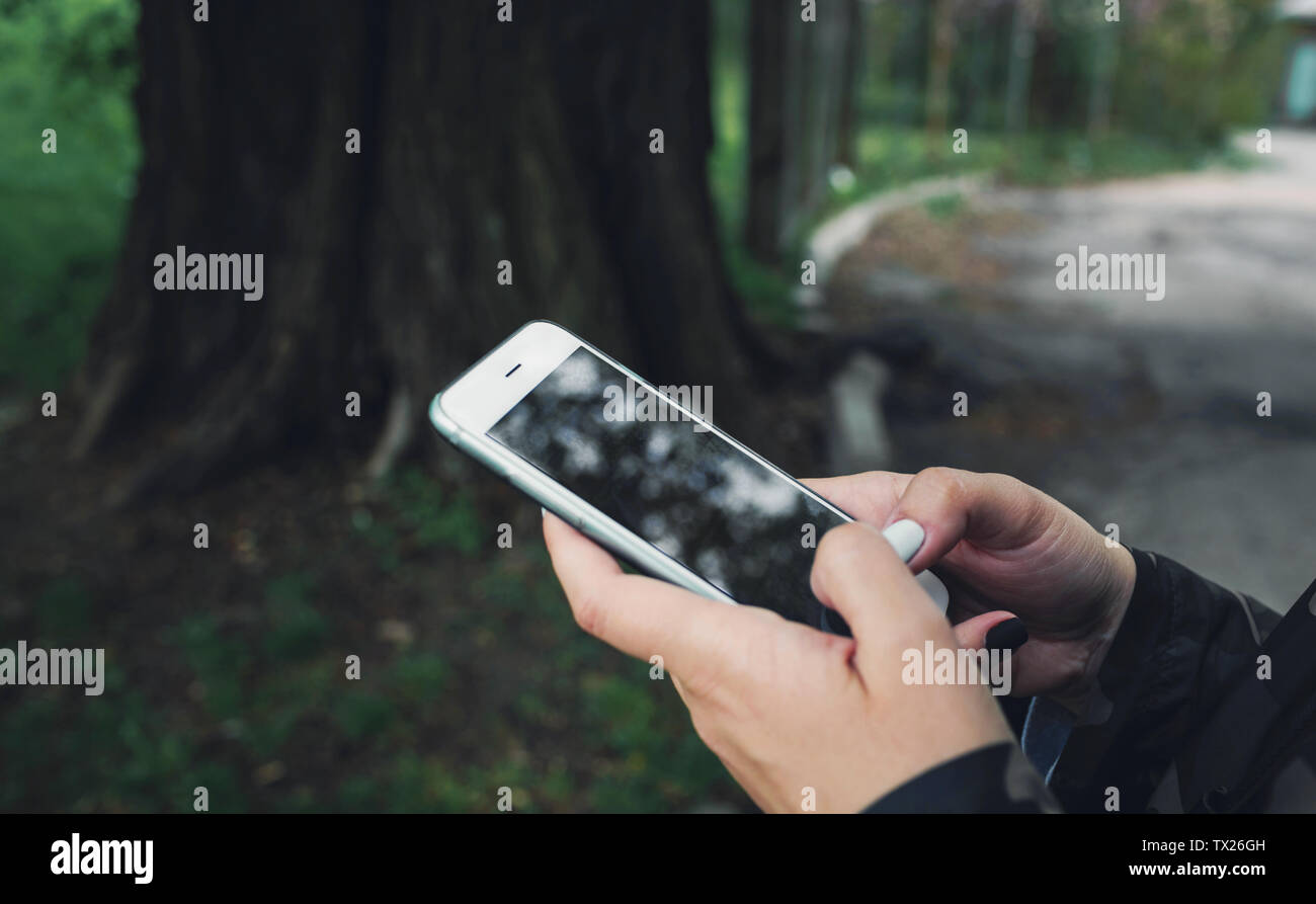 Hand holding mobile phone close up. Female hands texting on a ...