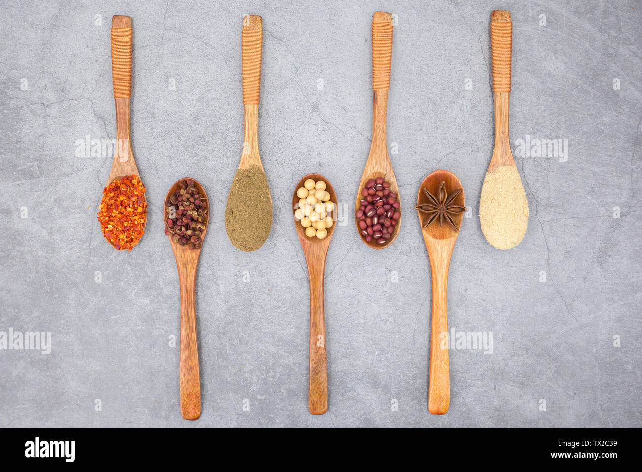 Multiple wooden spoons filled with various seasonings Stock Photo - Alamy