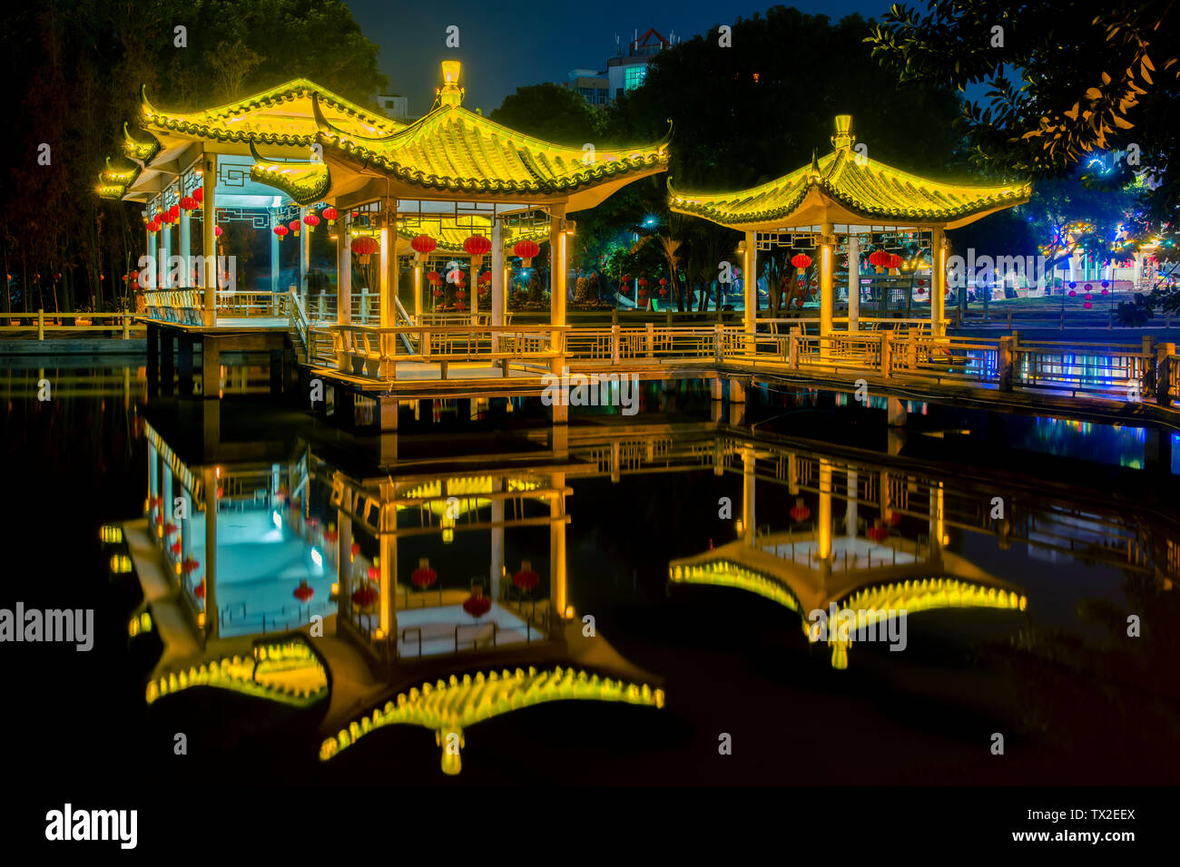 Golden pavilion with red lanterns at night Stock Photo - Alamy