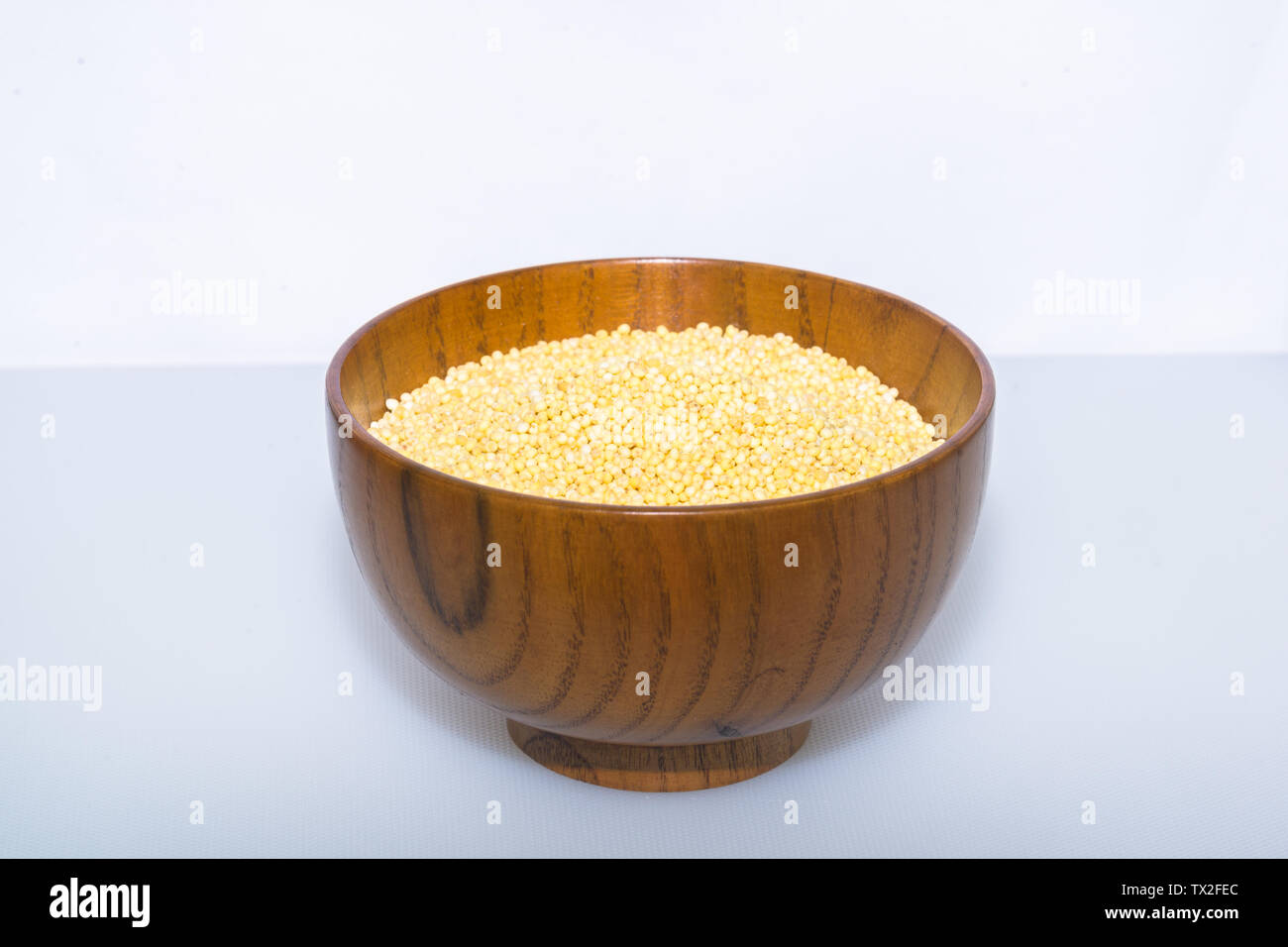The millet in a wooden bowl Stock Photo - Alamy