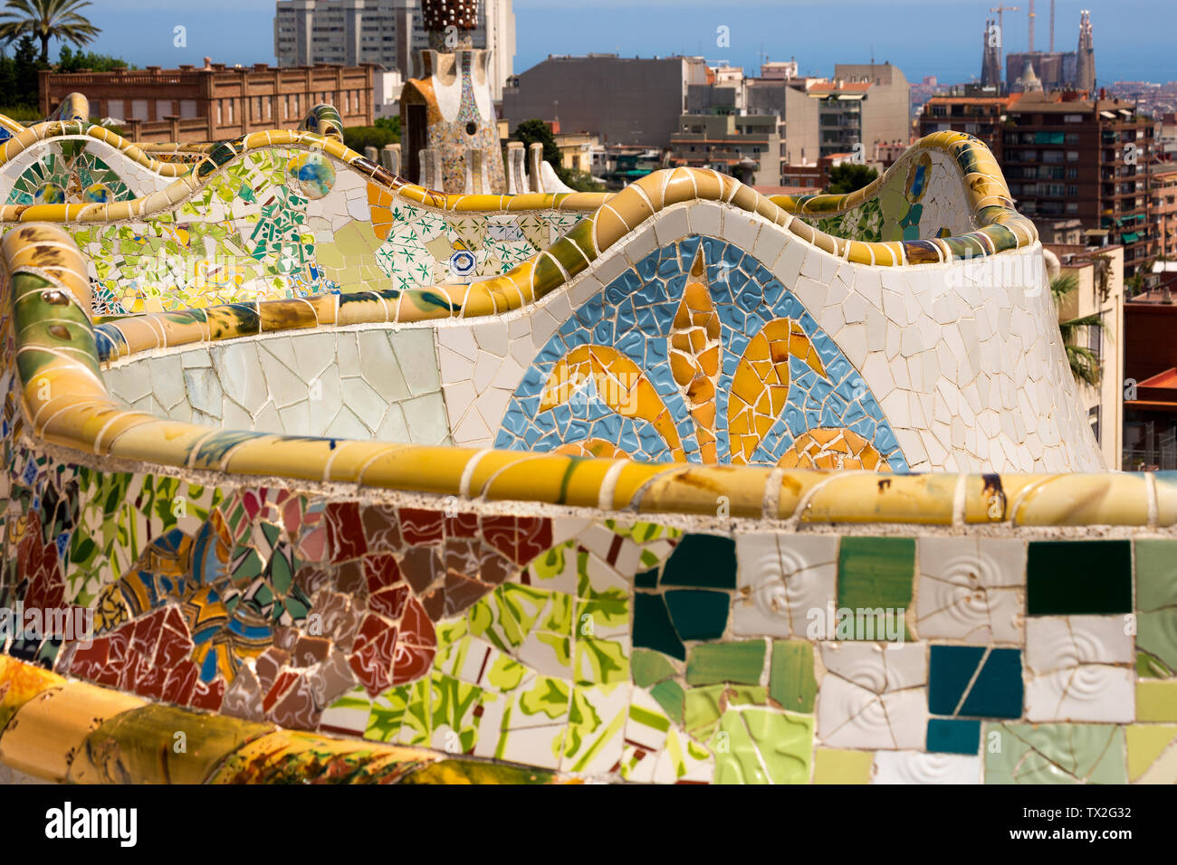 Ceramic bench and building in the Park Guell designed by the famous ...