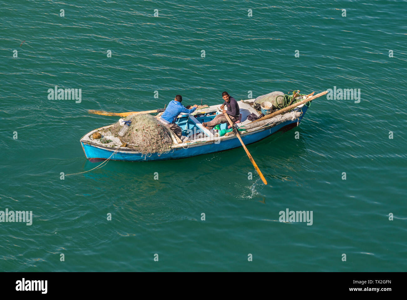 Ismailia, Egypt - November 5, 2017: Fishermen in wooden boat catch fish ...