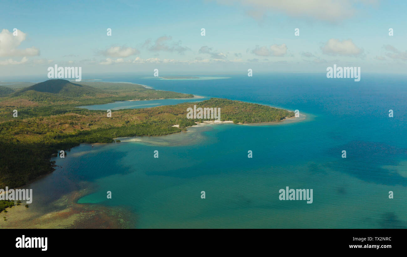 Tropical island Balabac covered with green rain forest against the blue ...