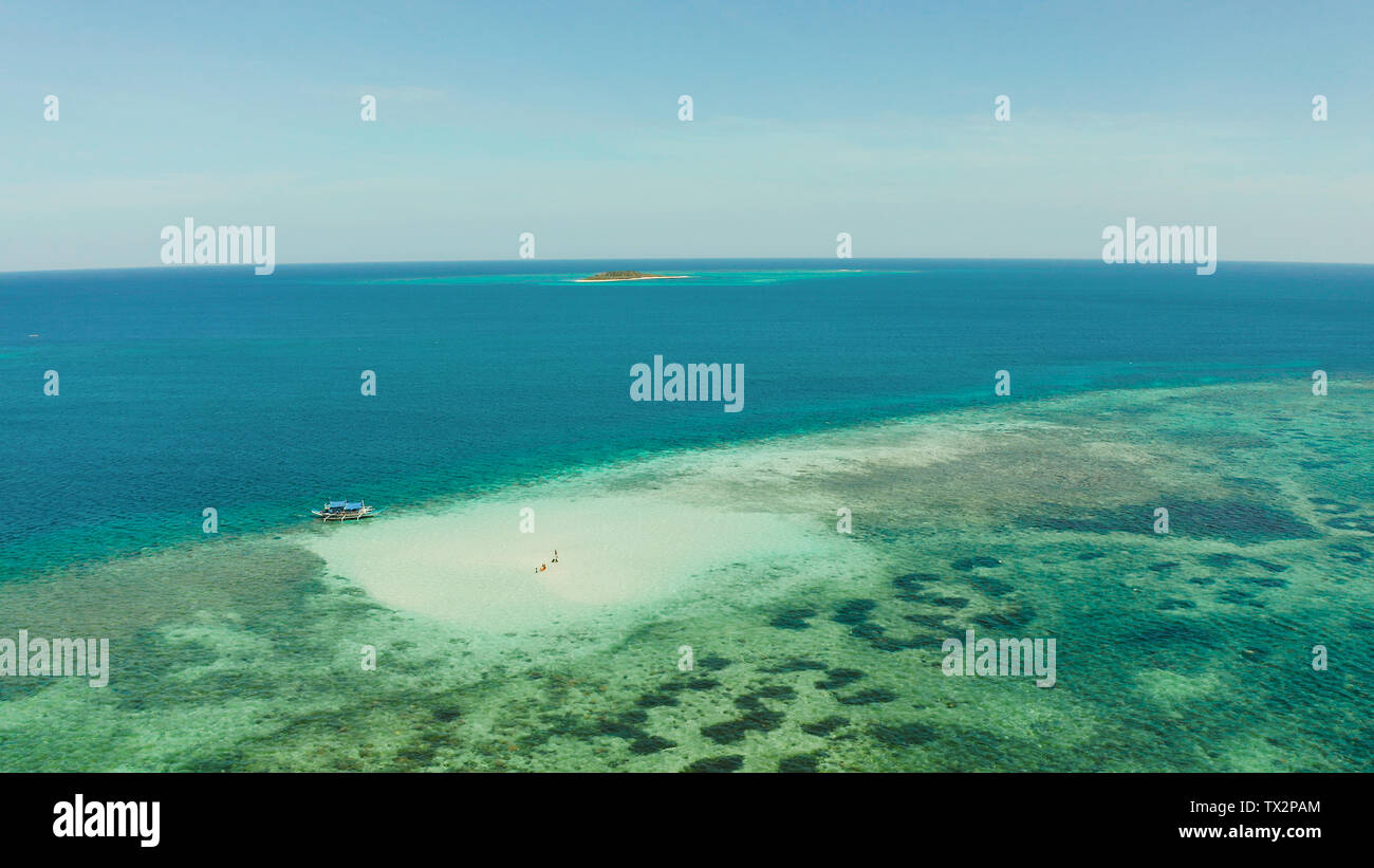 Sand bar among coral reefs in turquoise atoll water, top view. Summer ...