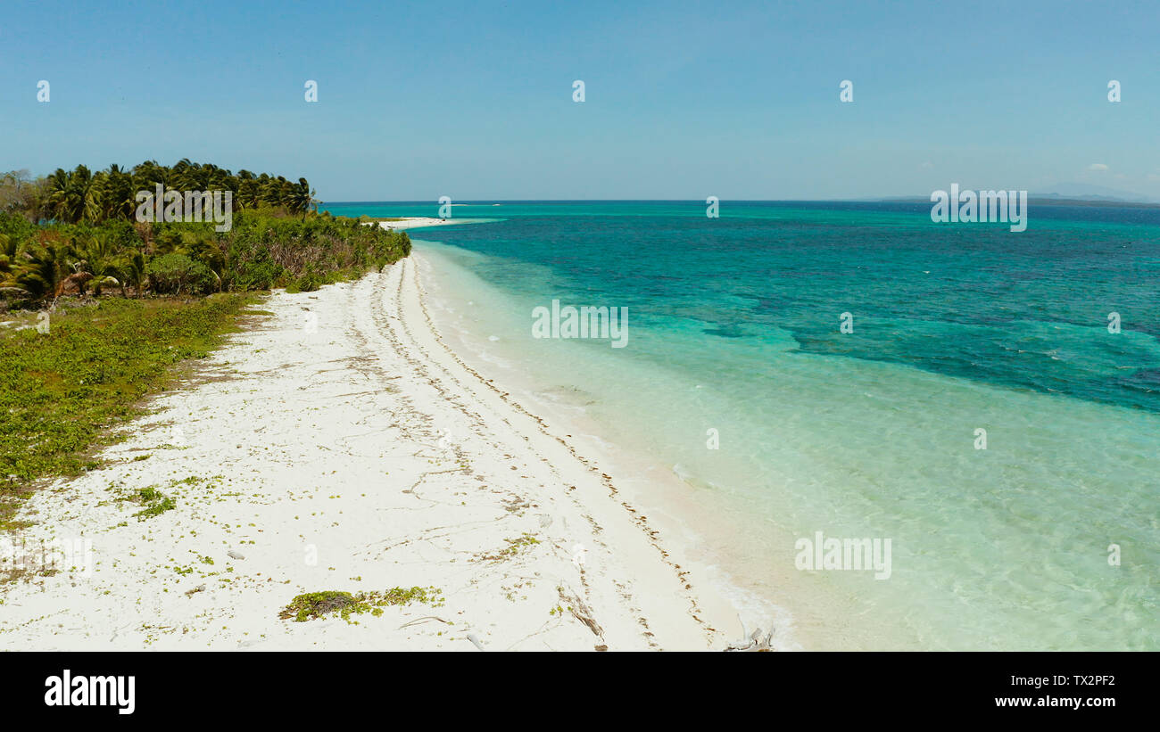 White sandy beach with turquoise water by atoll coral reef and blue sea ...
