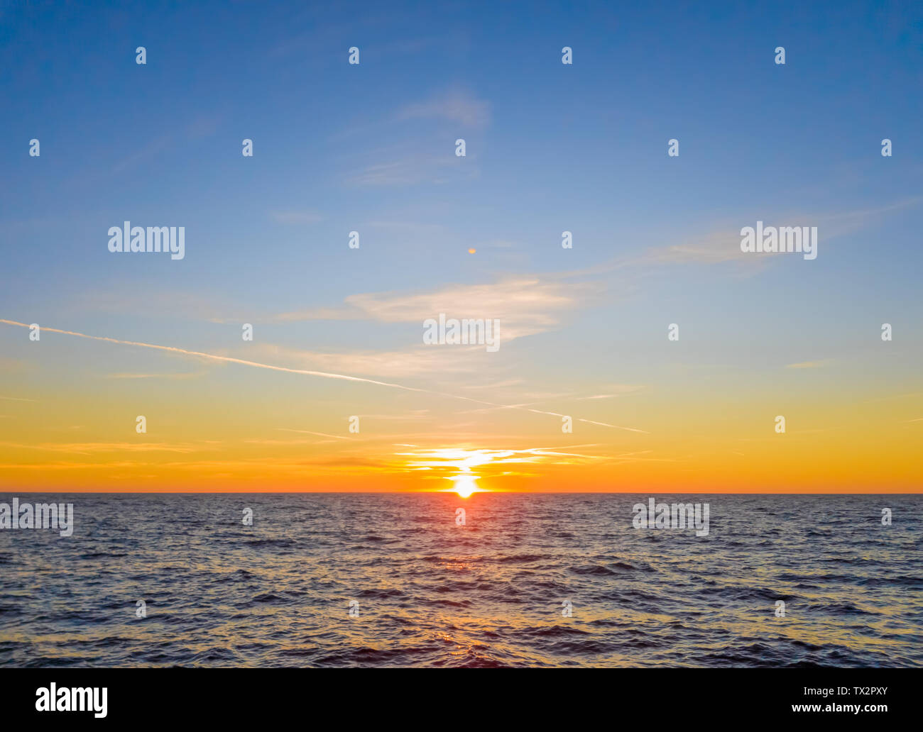 Orange sunset in the open sea Stock Photo - Alamy