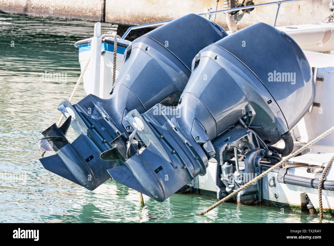 Couple of used blue outboard engines mounted on a speedboat Stock Photo ...