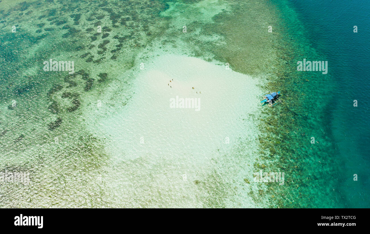 Sand bar among coral reefs in turquoise atoll water, top view. Summer ...