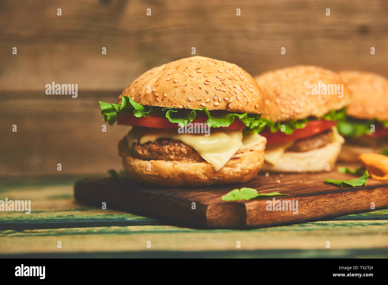 Craft beef burger on wooden table isolated on black background. Street ...