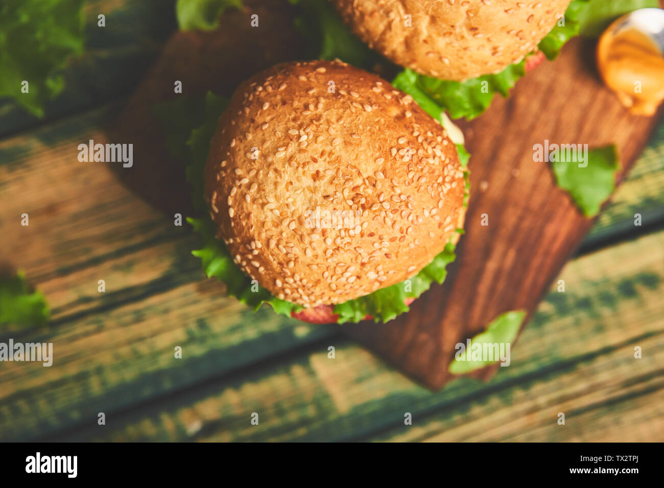 Craft beef burger on wooden table isolated on black background. Street ...