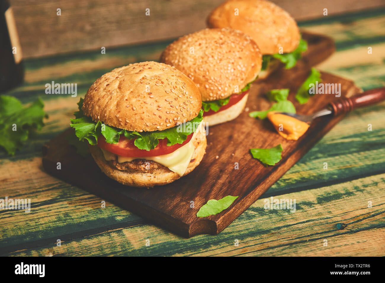 Craft beef burger on wooden table isolated on black background. Street ...