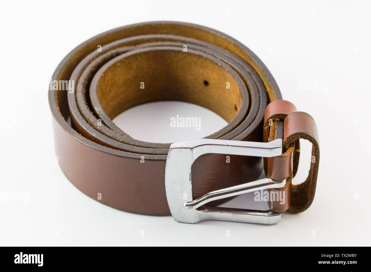 Old leather belt roll on white background Stock Photo - Alamy