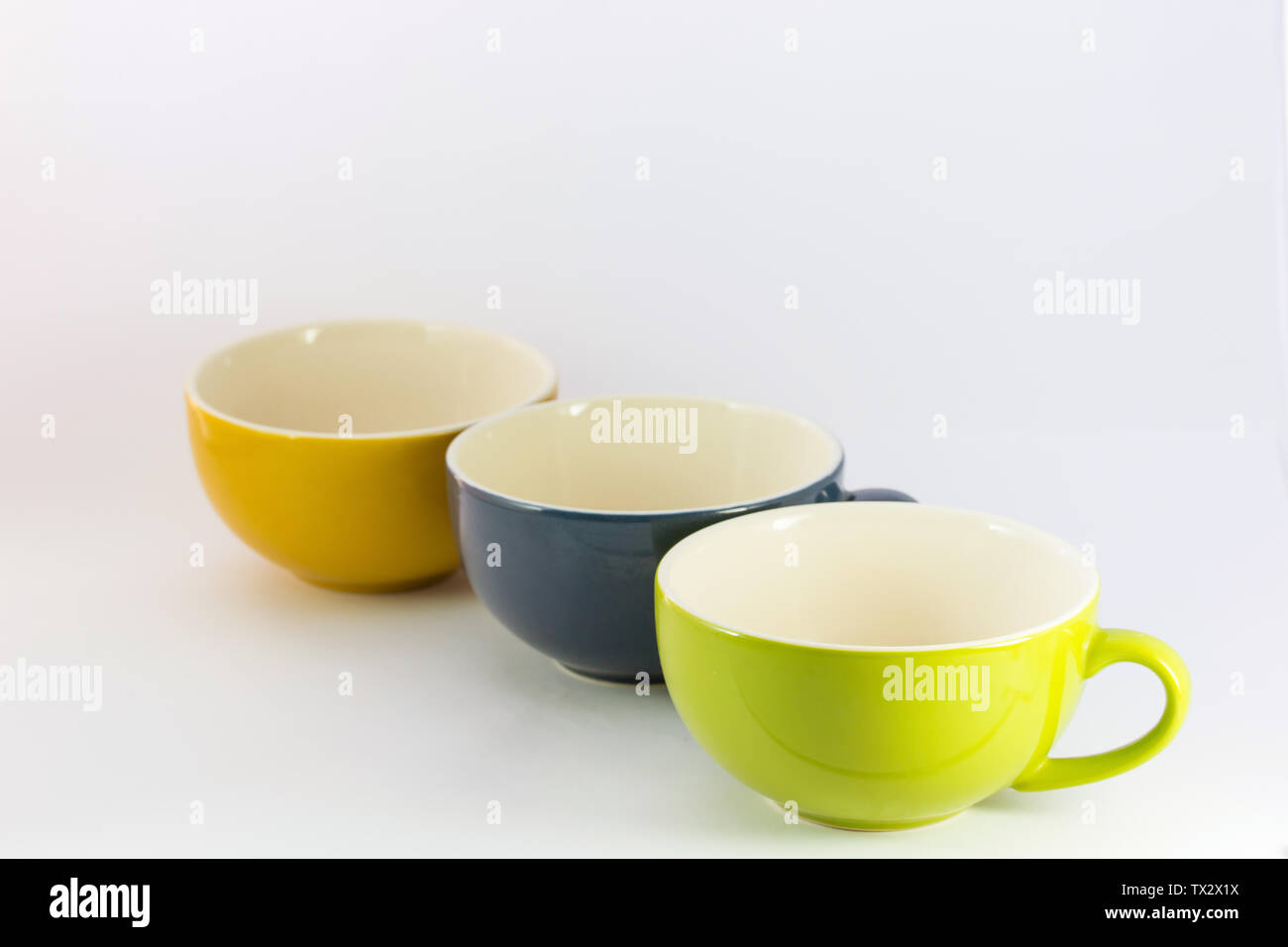 Three cups color of coffee on white background Stock Photo - Alamy