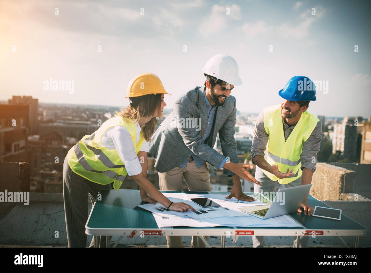 Group of engineers, architects, business partners at construction site ...