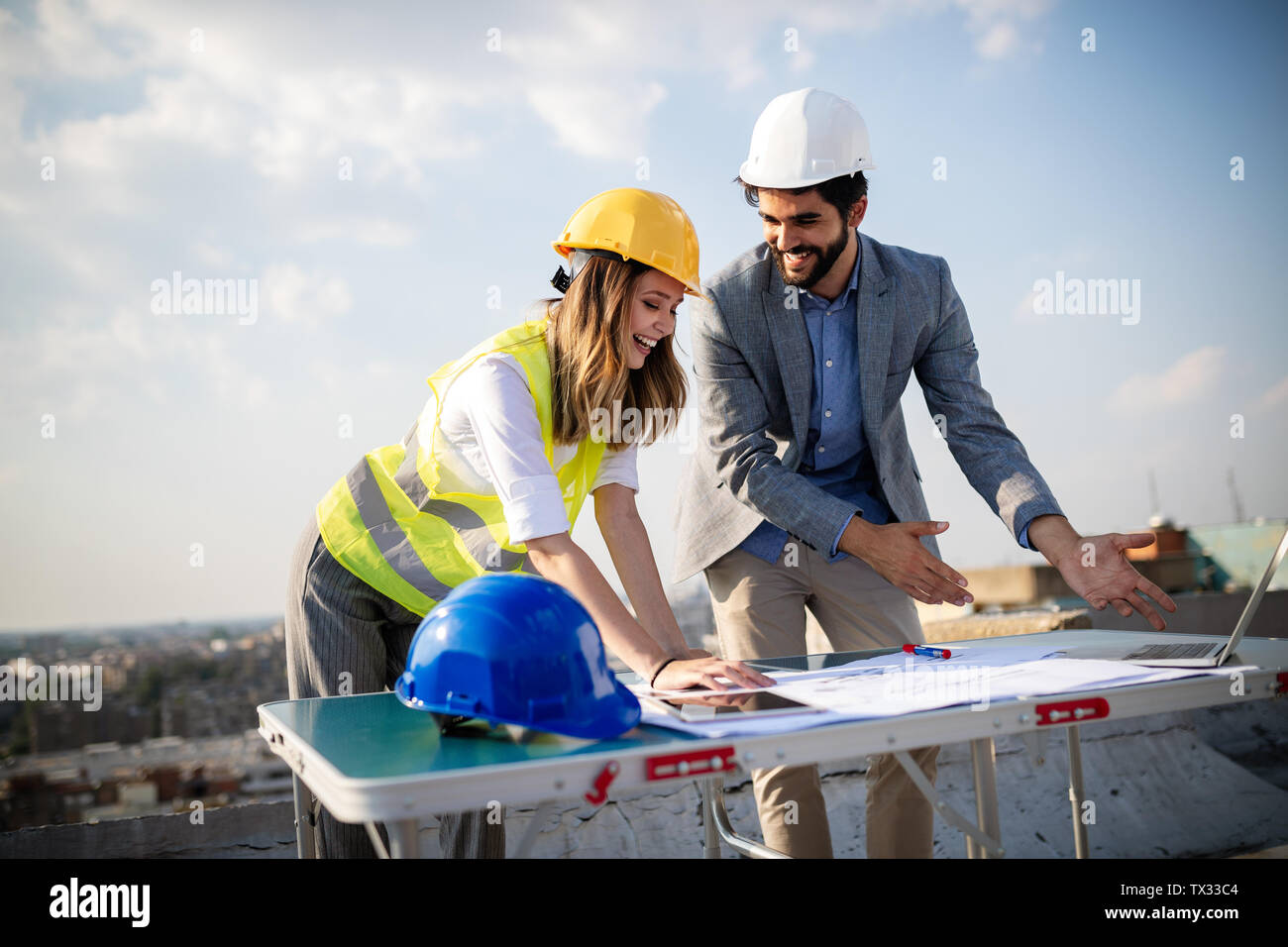 Group of engineers, architects, business partners at construction site ...