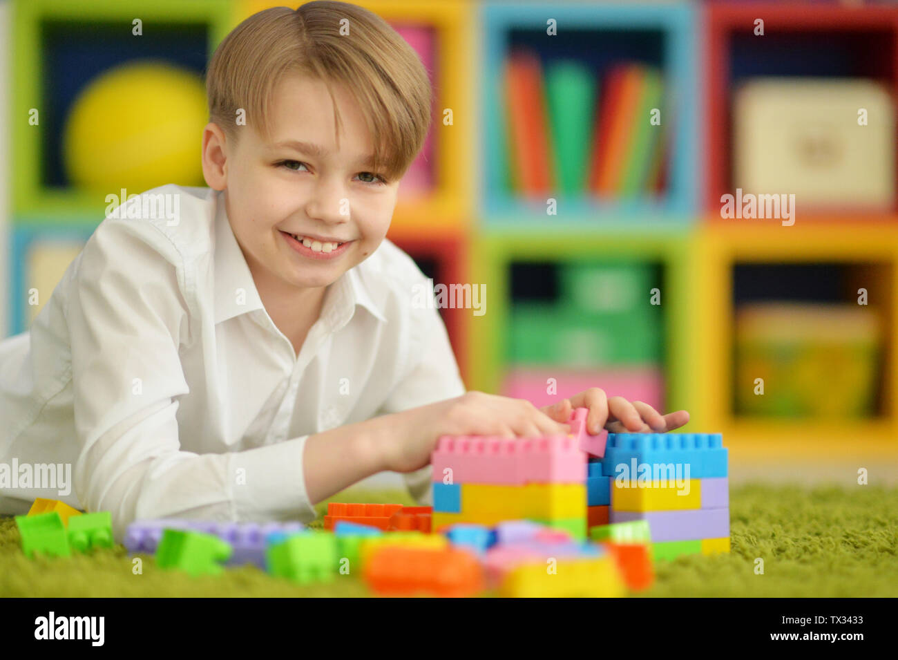 Cute little boy playing with colorful plastic blocks Stock Photo - Alamy