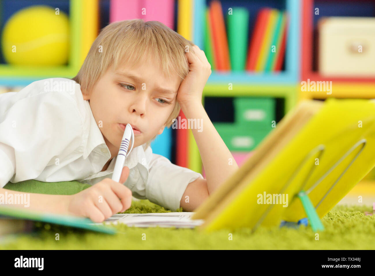 Portrait of cute little boy doing homework Stock Photo - Alamy