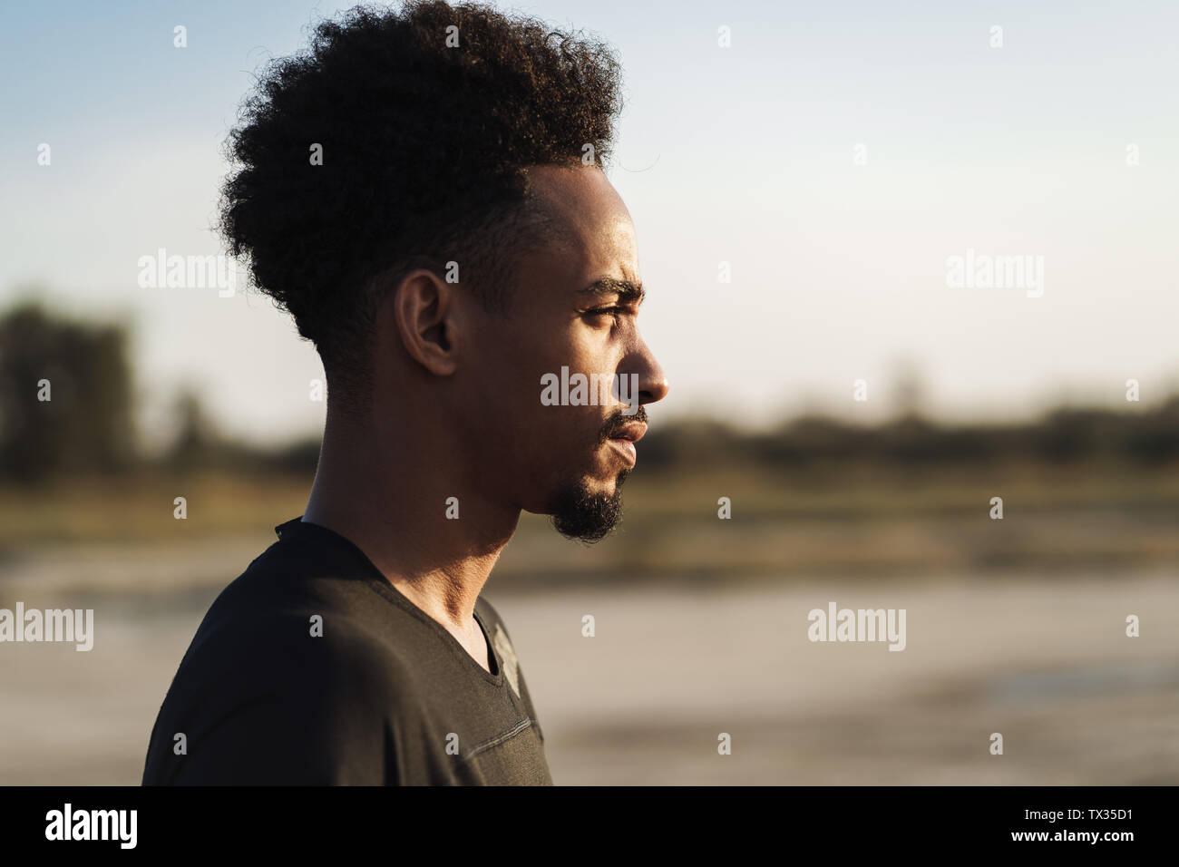 Side view image of a handsome young african strong sports man posing ...