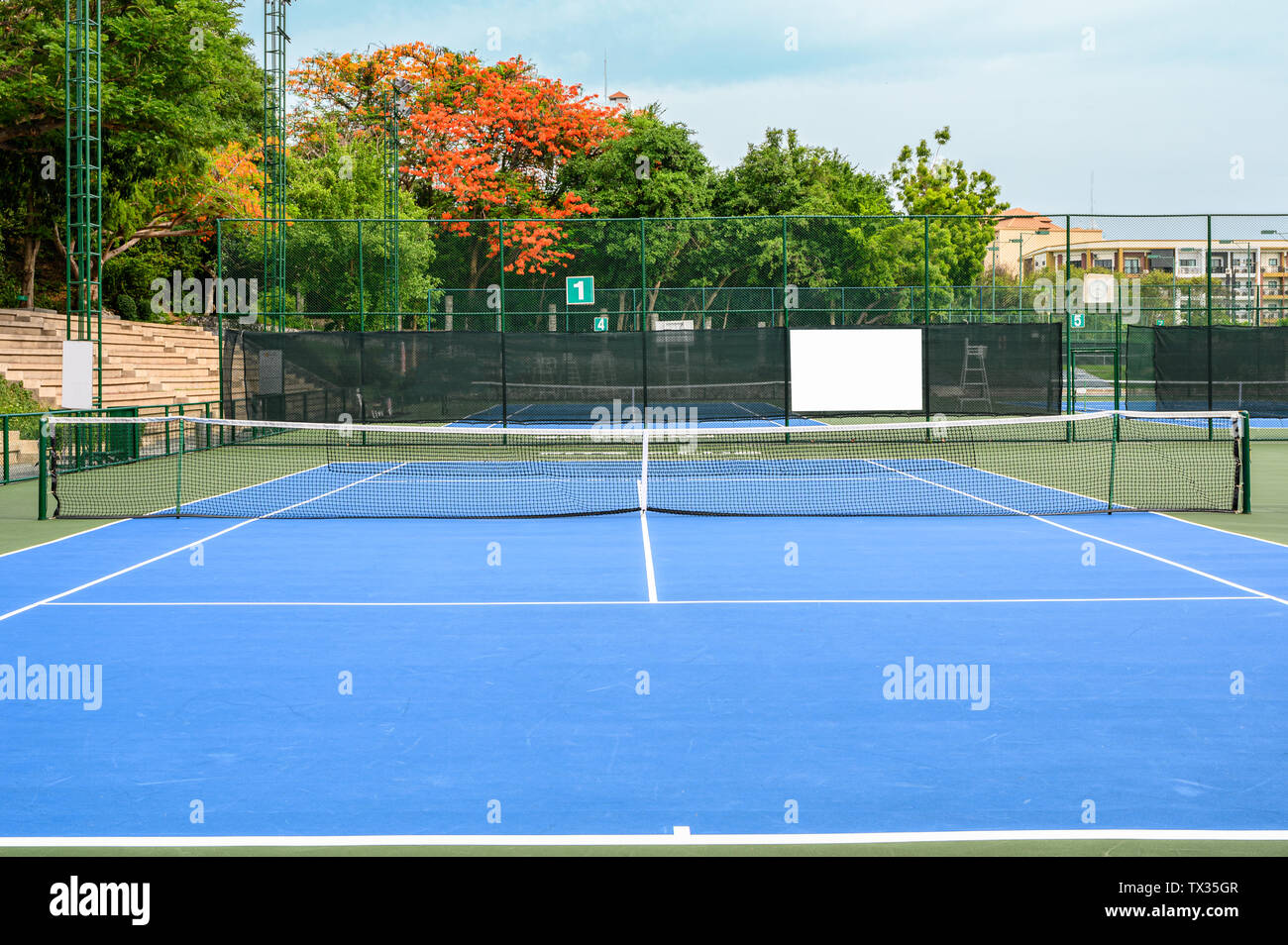 Whole blue tennis court, synthetic rubber field Stock Photo - Alamy